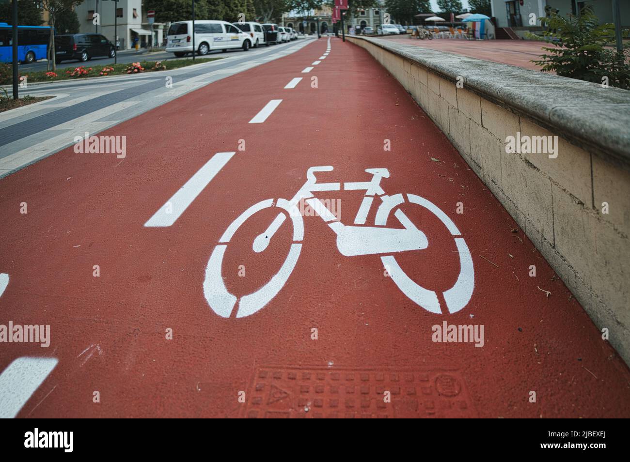 Bicycle lane sign on dedicated path with ruby red color background ...
