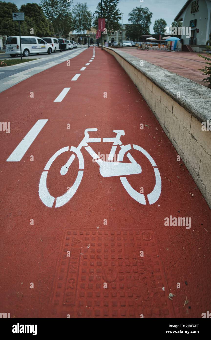 Bicycle lane sign on dedicated path with ruby red color background ...