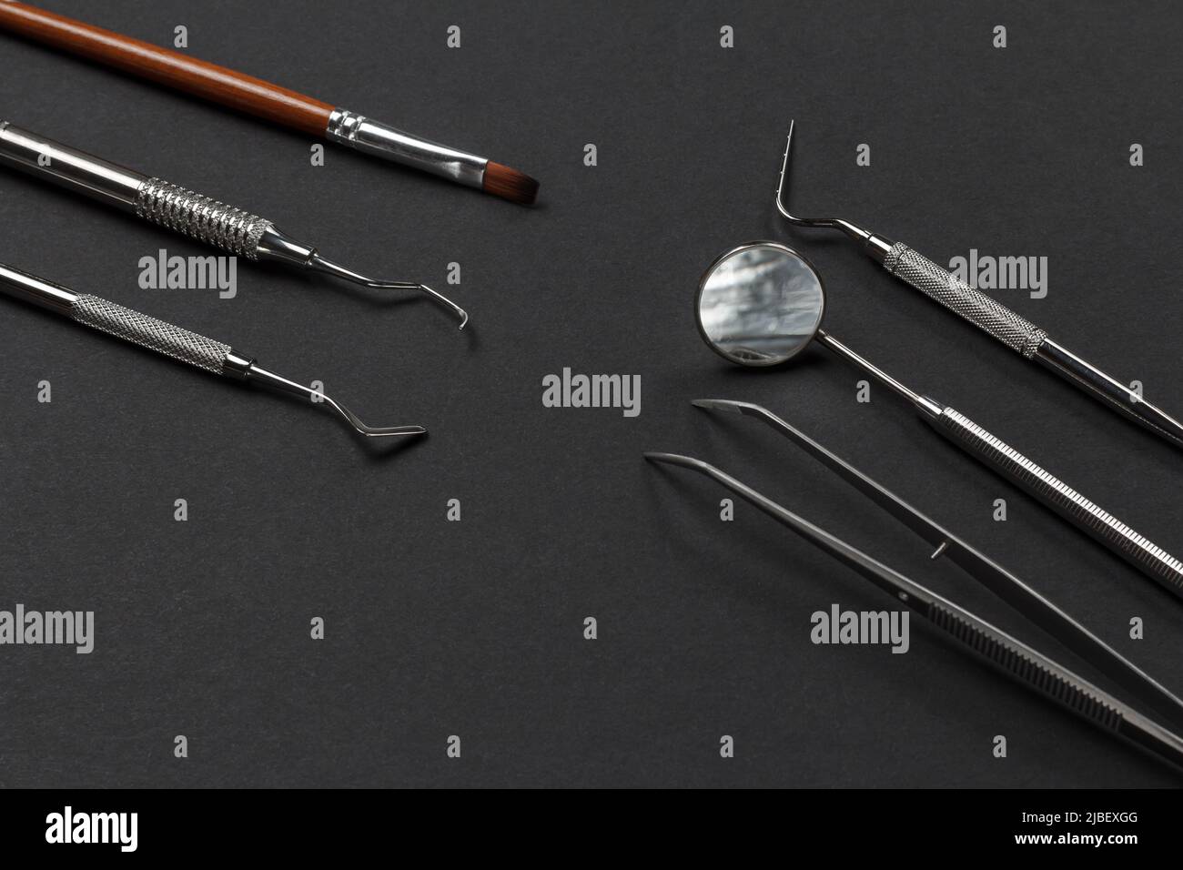 High-speed dental handpiece with bur, tweezers, a mouth mirror and a ...