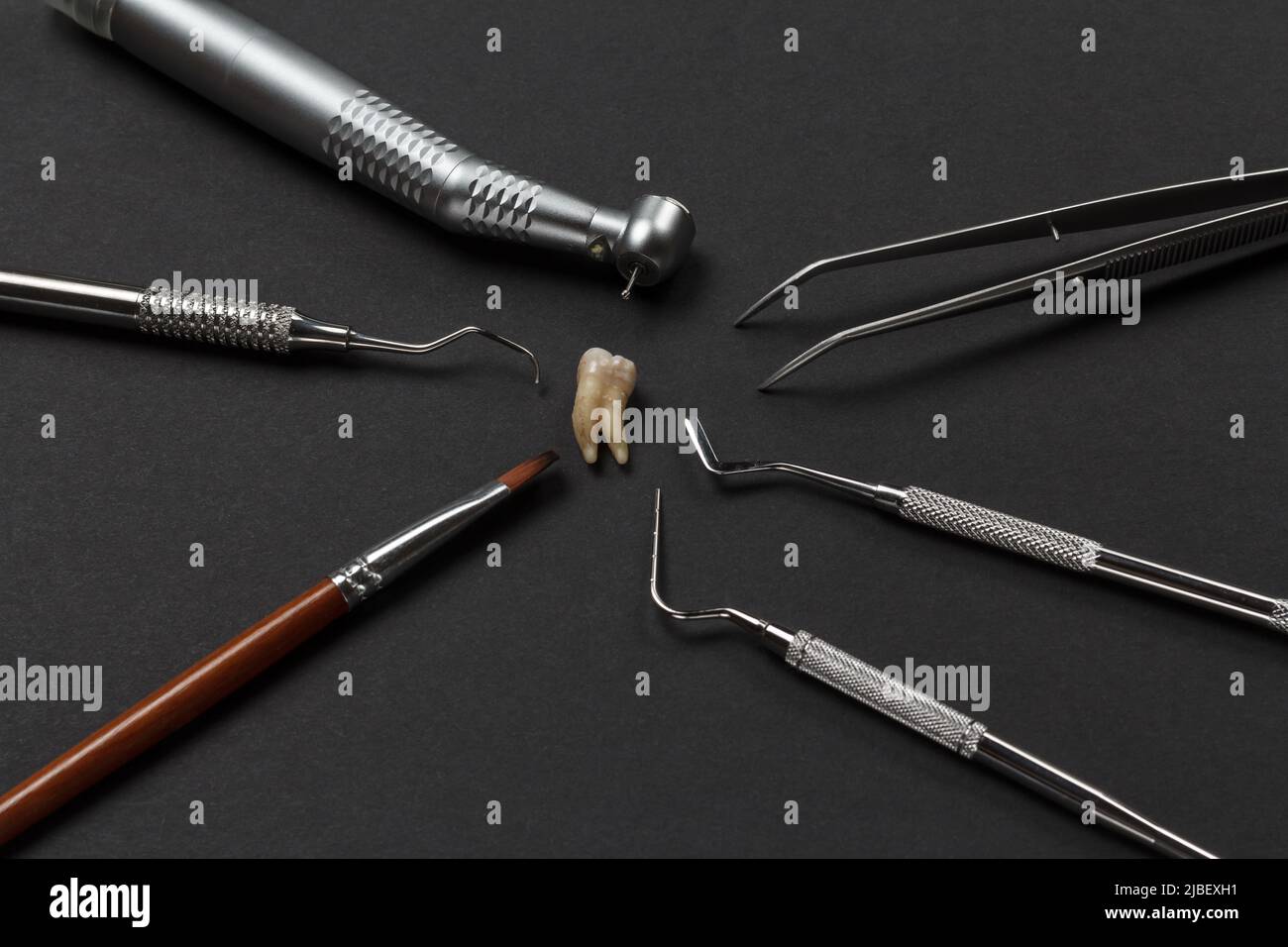 High-speed dental handpiece with bur, tweezers and pluggers. Dental ...