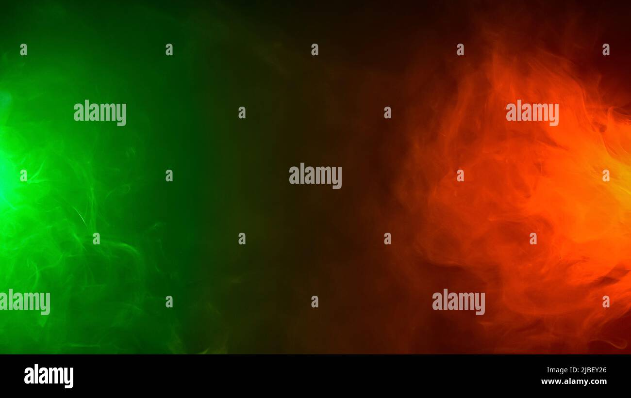 Red green smoke on a black background Stock Photo - Alamy