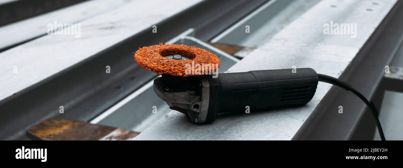 Sander for metal beams on construction site. Professional portable ...