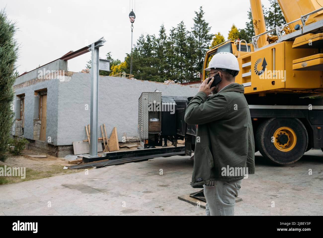 Foreman talking by phone on construction site. architect discussing ...