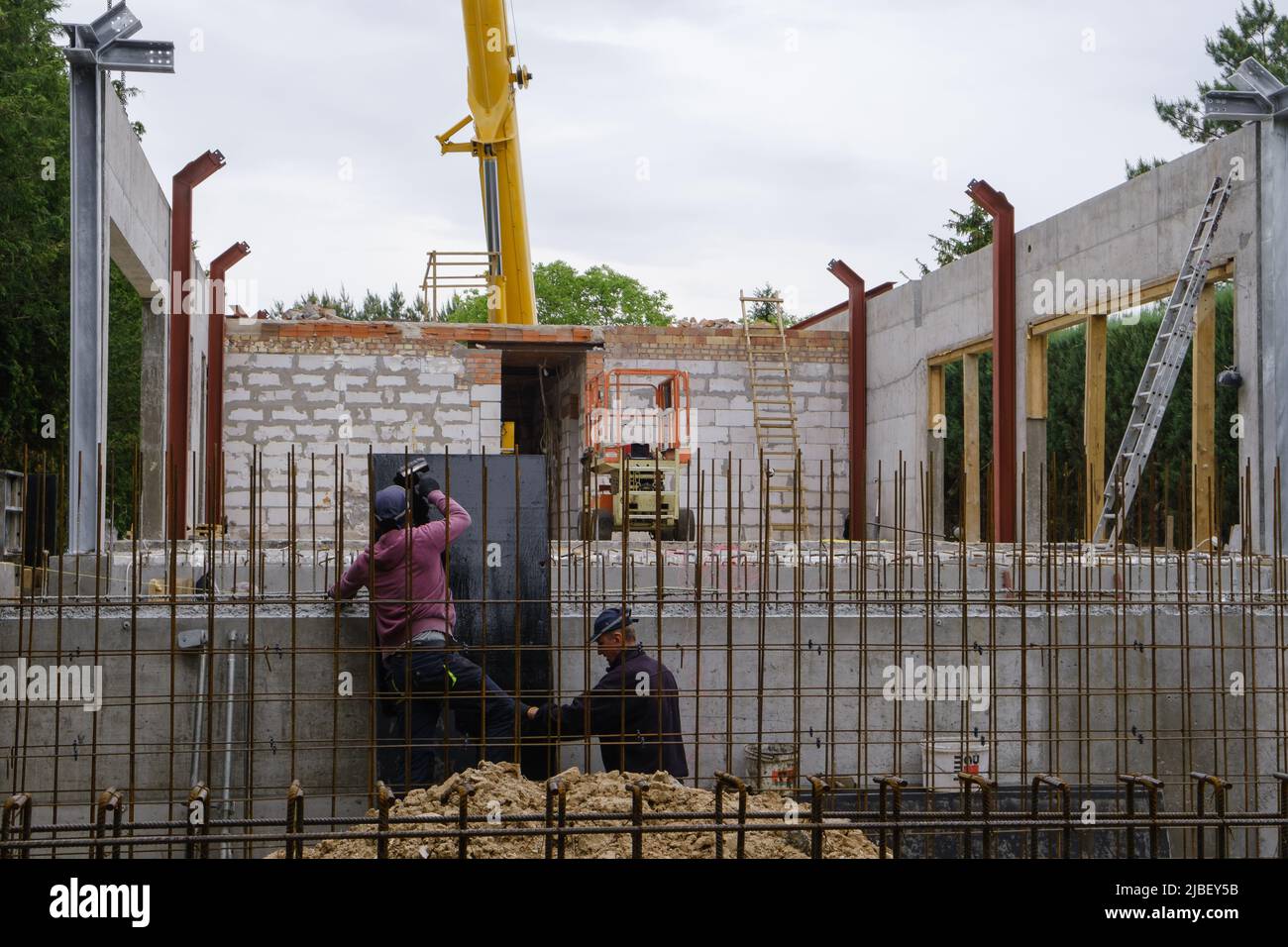 man working at construction site building private house and reinforced ...