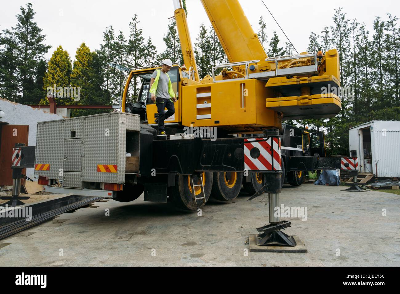 Operator on Construction crane lifting heavy freight. Modern mobile ...