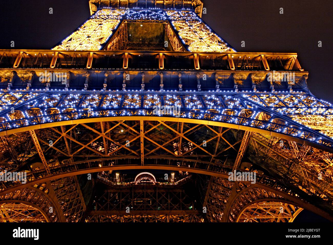 Part of the Eiffel Tower illuminated at night Stock Photo - Alamy
