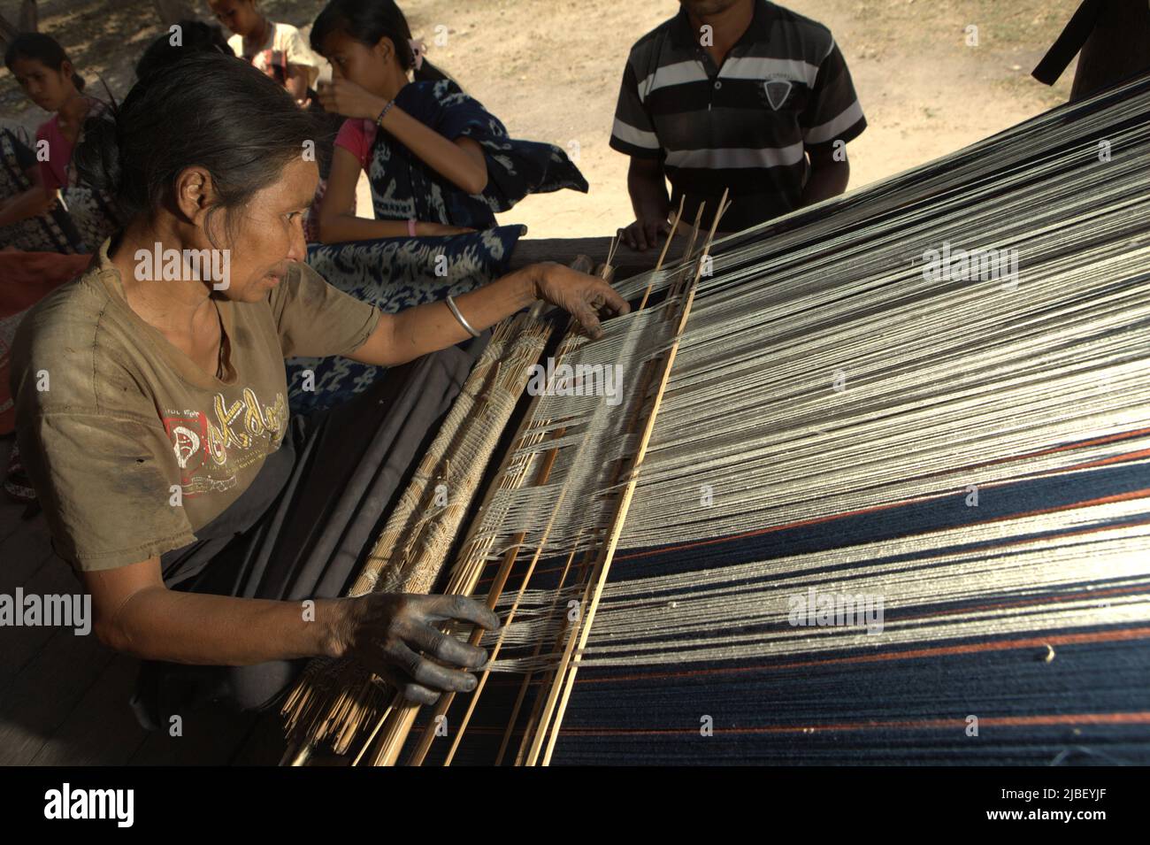 A woman weaving traditional woven textile in Umabara village, Watu ...