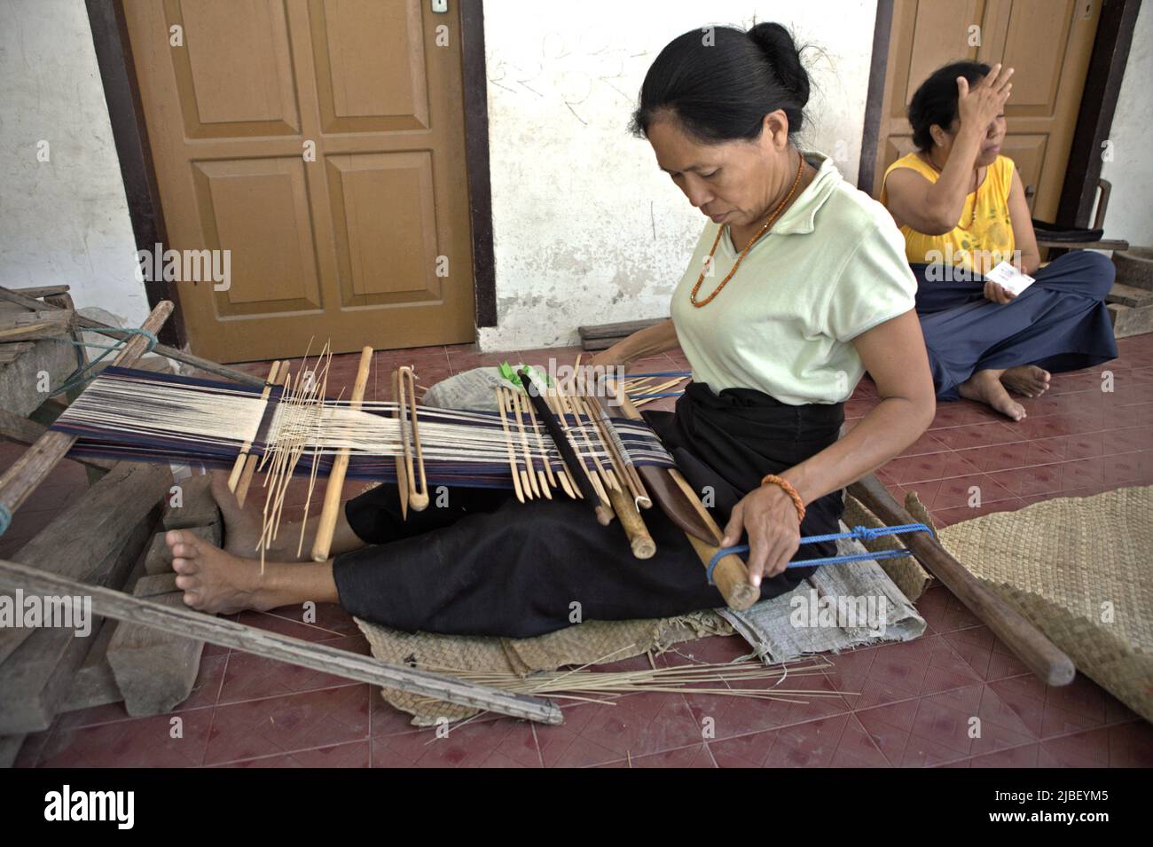 A woman weaving traditional woven textile in Umabara village, Watu ...