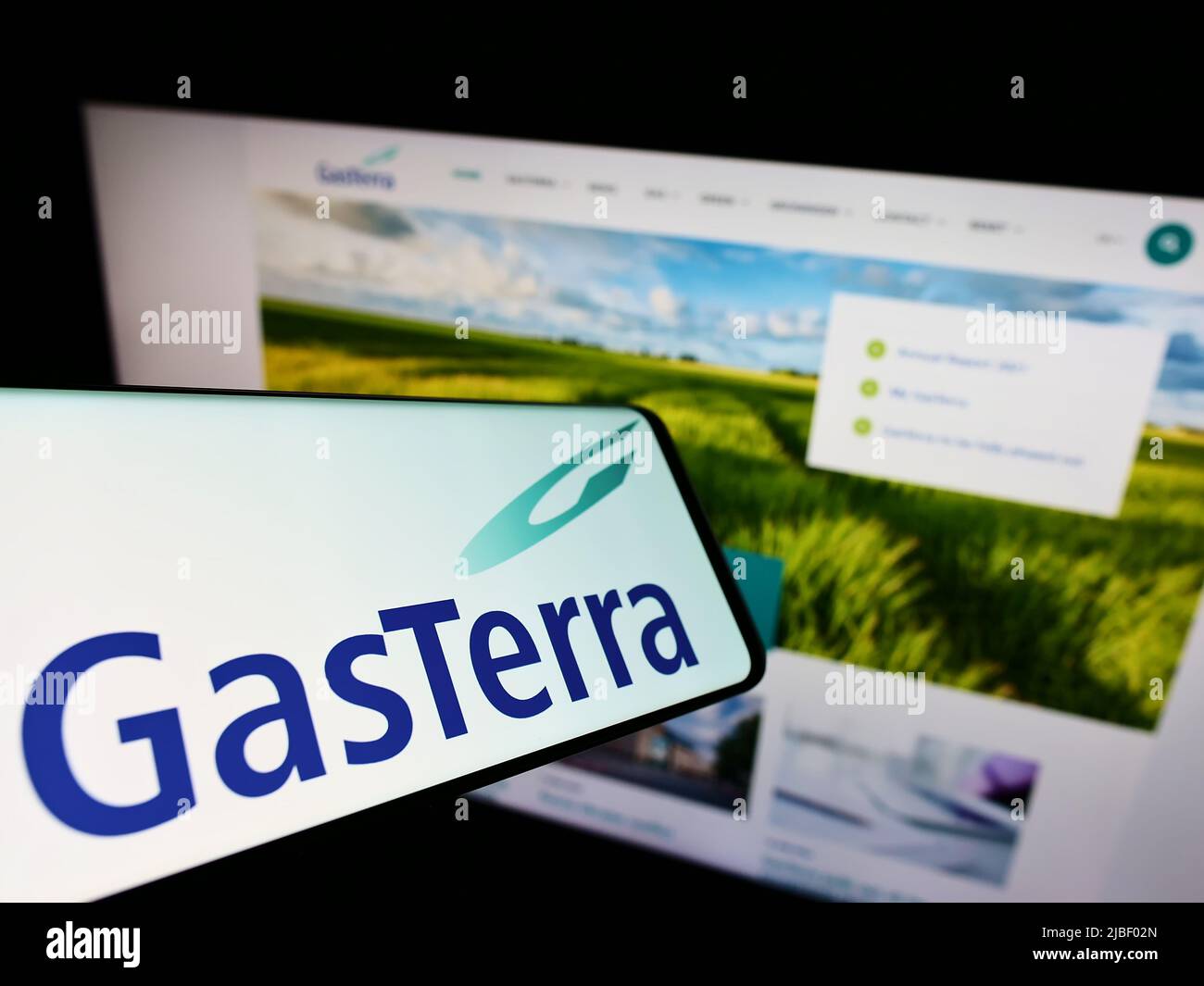 Cellphone with logo of Dutch energy company GasTerra B.V. on screen in ...