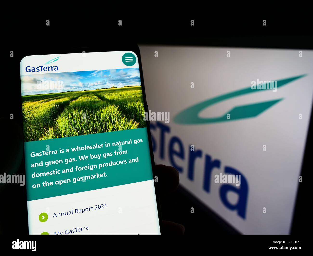 Person holding smartphone with website of Dutch energy company GasTerra ...