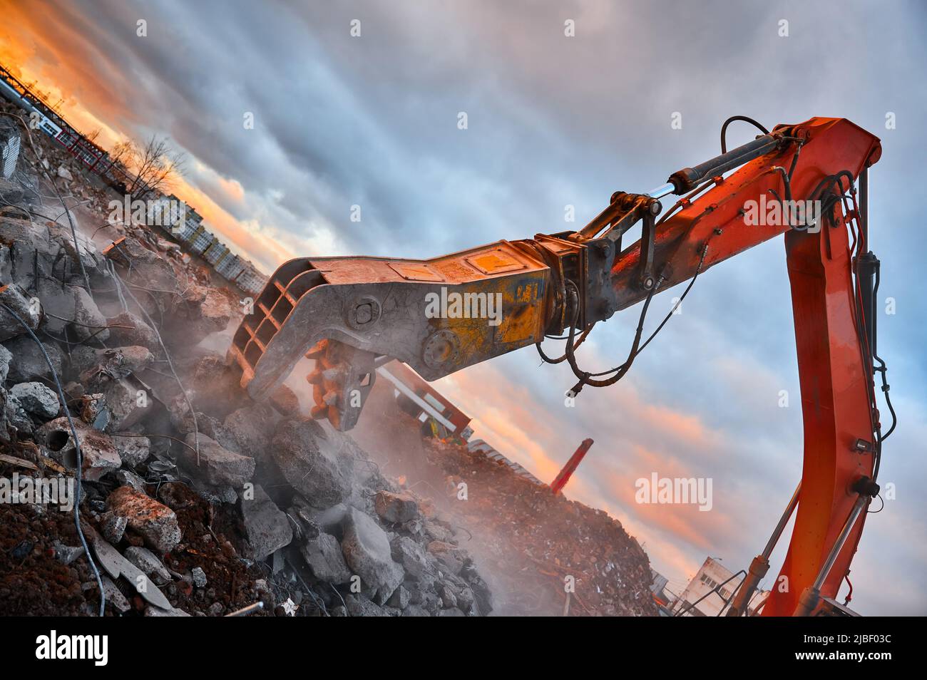 Excavator with concrete crusher on rig at demolition site Stock Photo ...