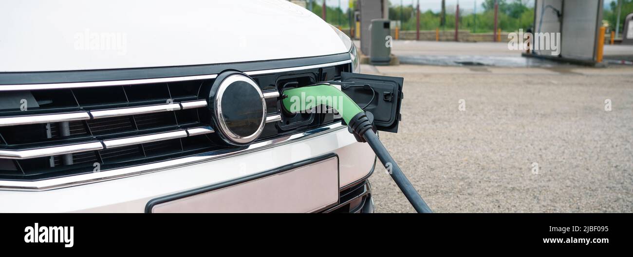 Socket plugged into electric car Stock Photo - Alamy