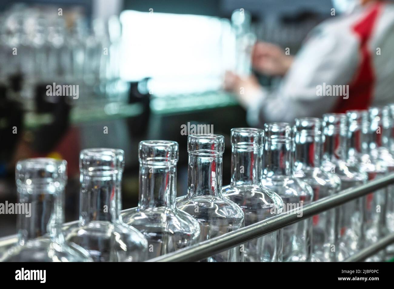Long row of empty glass bottles for alcohol drinks at plant Stock Photo ...