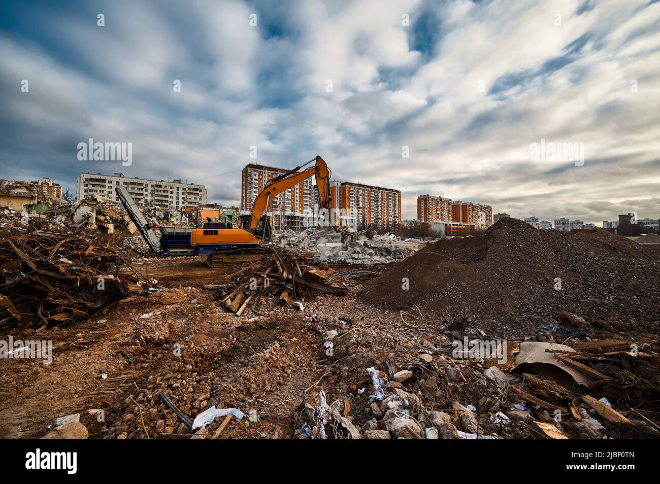 Excavator with hydraulic press breaks concrete leftovers Stock Photo - Alamy
