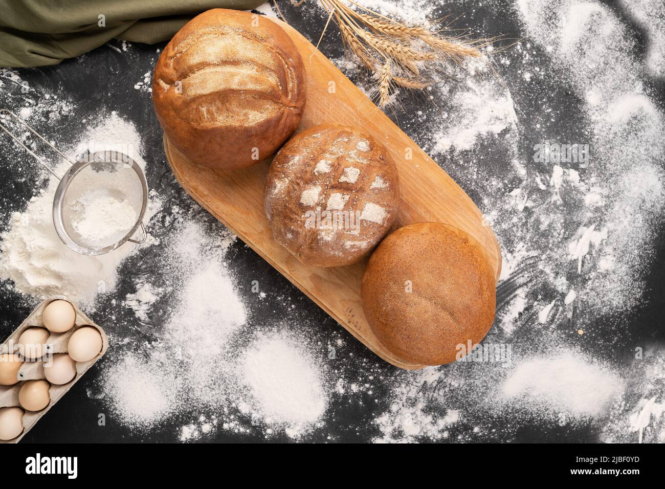 three round natural breads with wheat and rye flour. variety of bakery ...