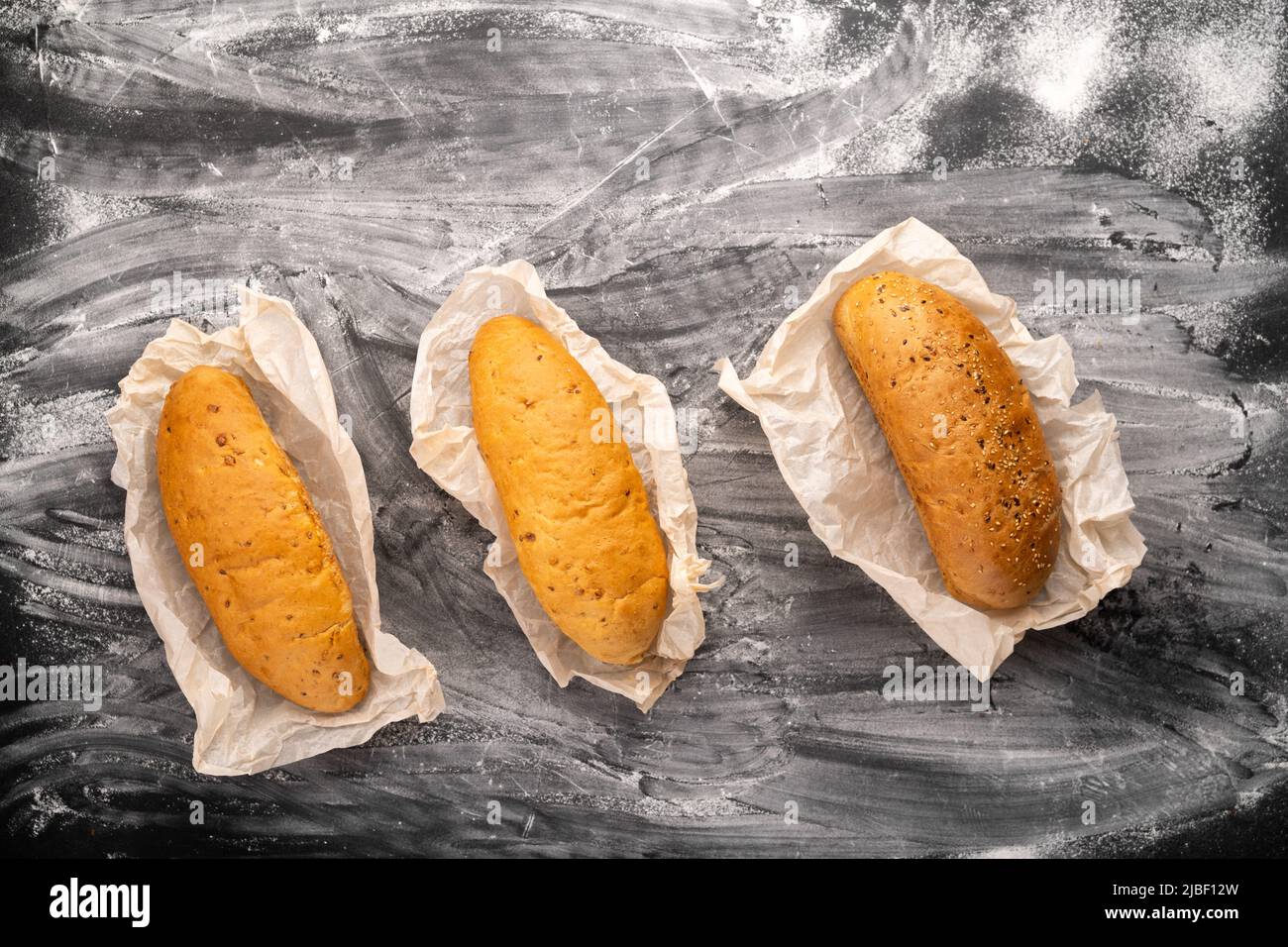 Assortment of delicious freshly baked bread on a black concrete ...