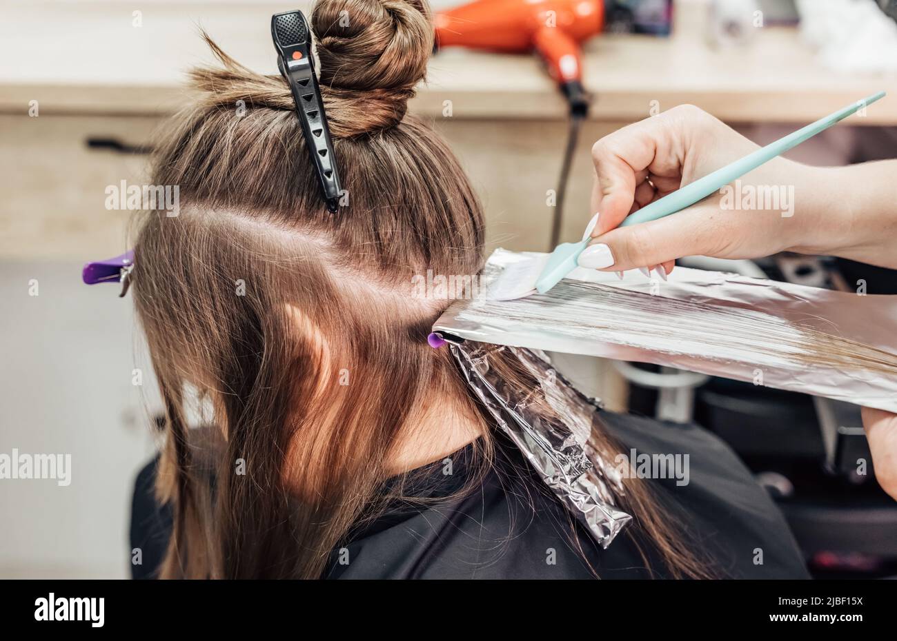 Woman dying hair with gloves hi-res stock photography and images - Alamy