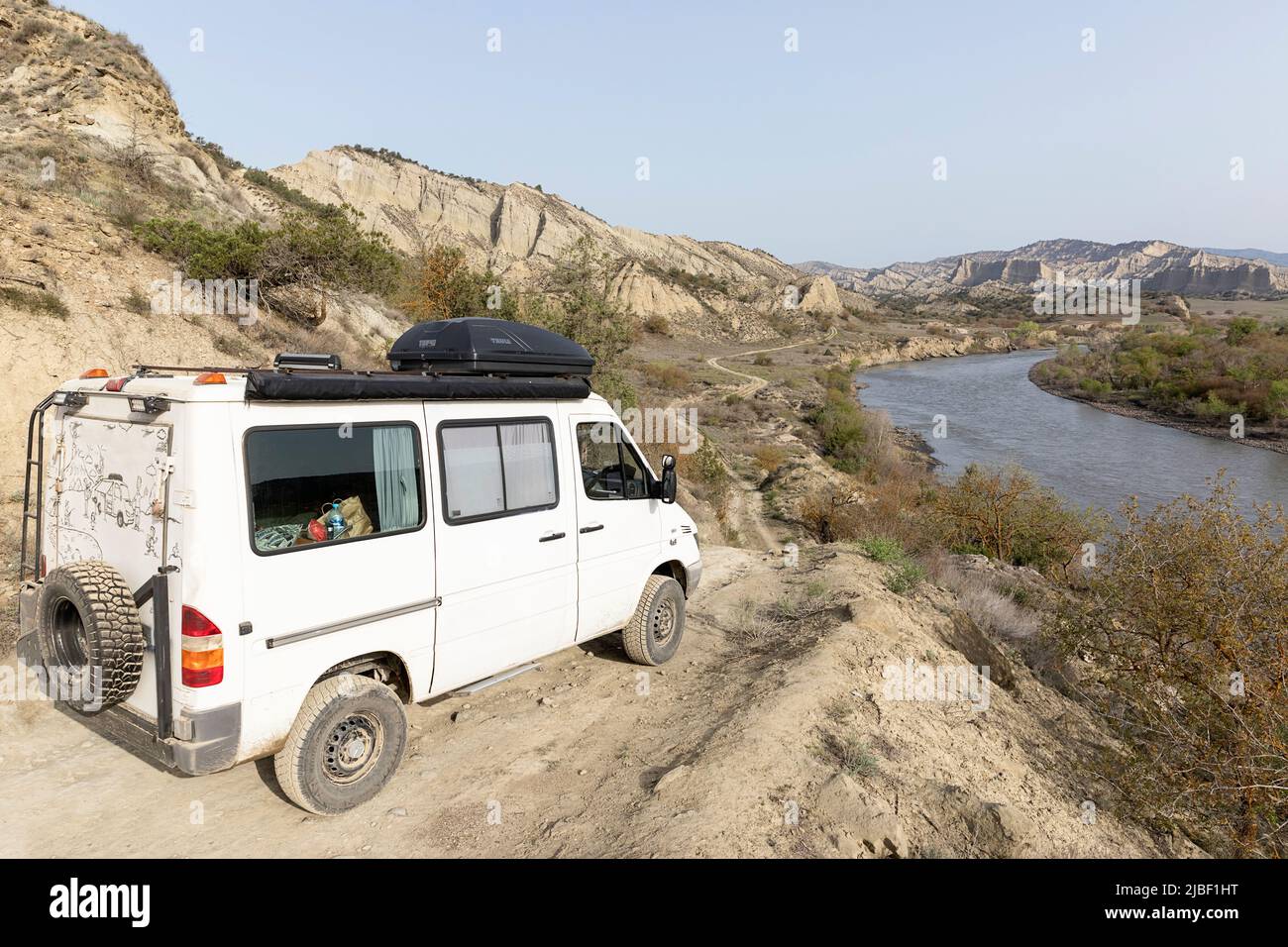 Tourist 4x4 campervan on a gravel road near Alazani river in a remote ...