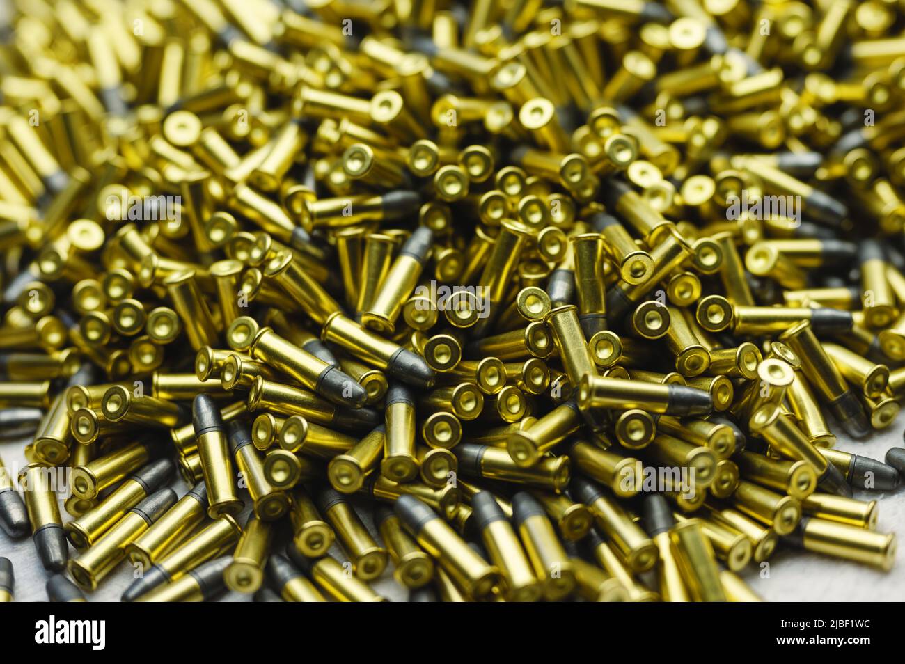 Small-caliber bullets on white table at production plant Stock Photo ...