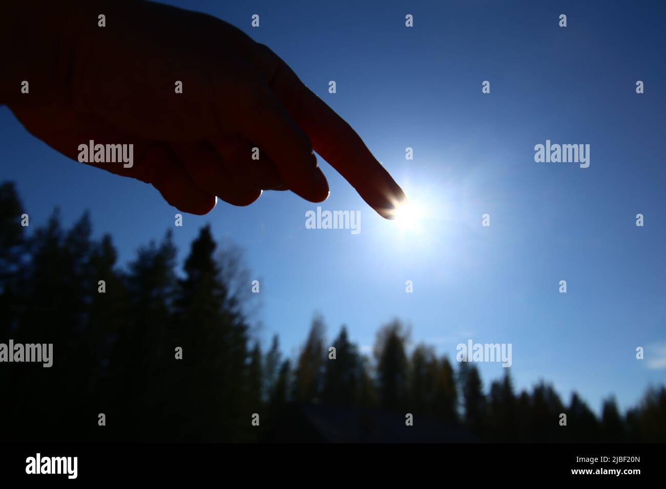 Pointing at the sun on a clear blue sky Stock Photo - Alamy
