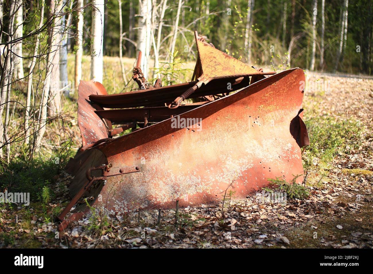 Historic rusty snow plow lying in the forest Stock Photo - Alamy