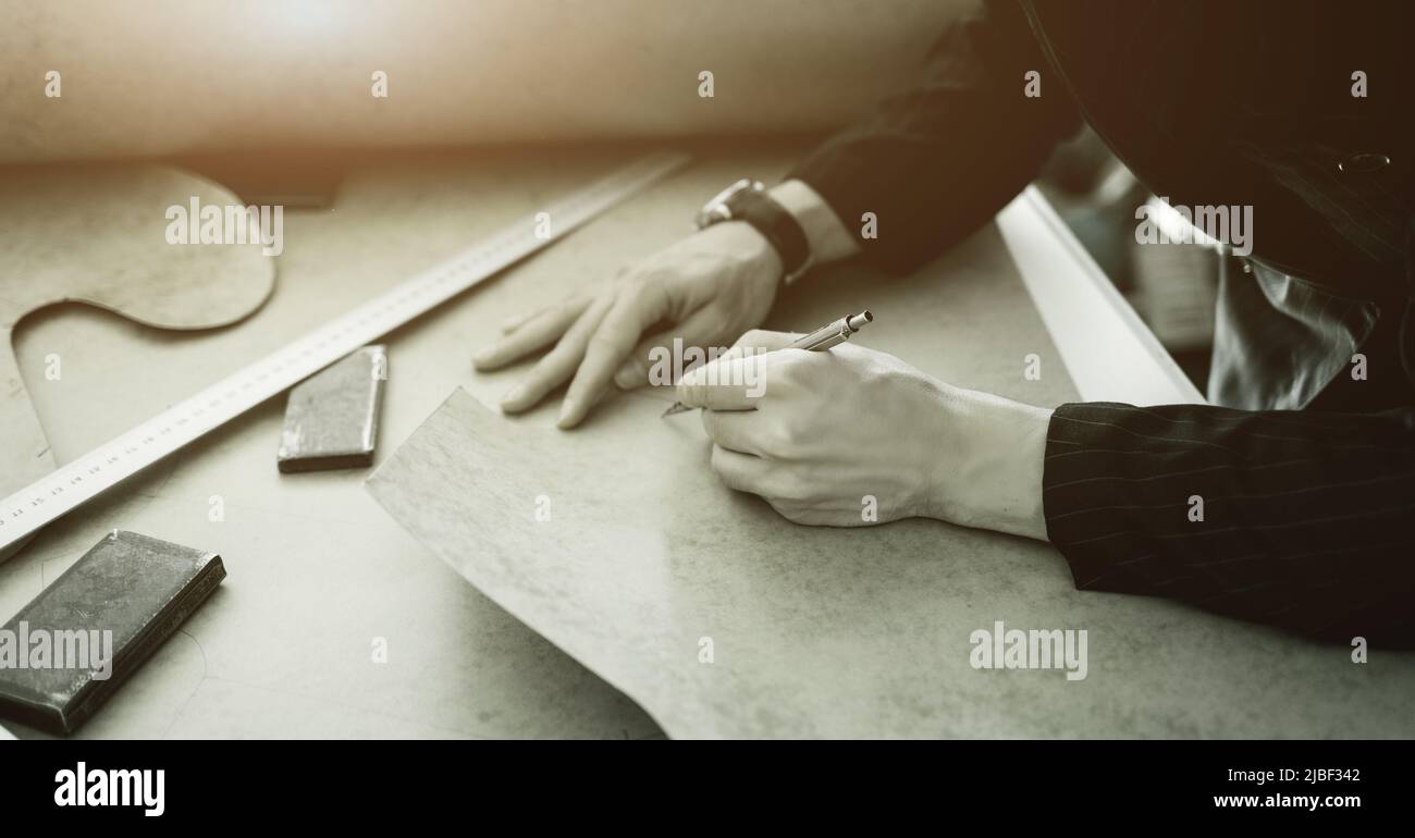 tailor working with sewing pattern in atelier. handmade. designer in ...