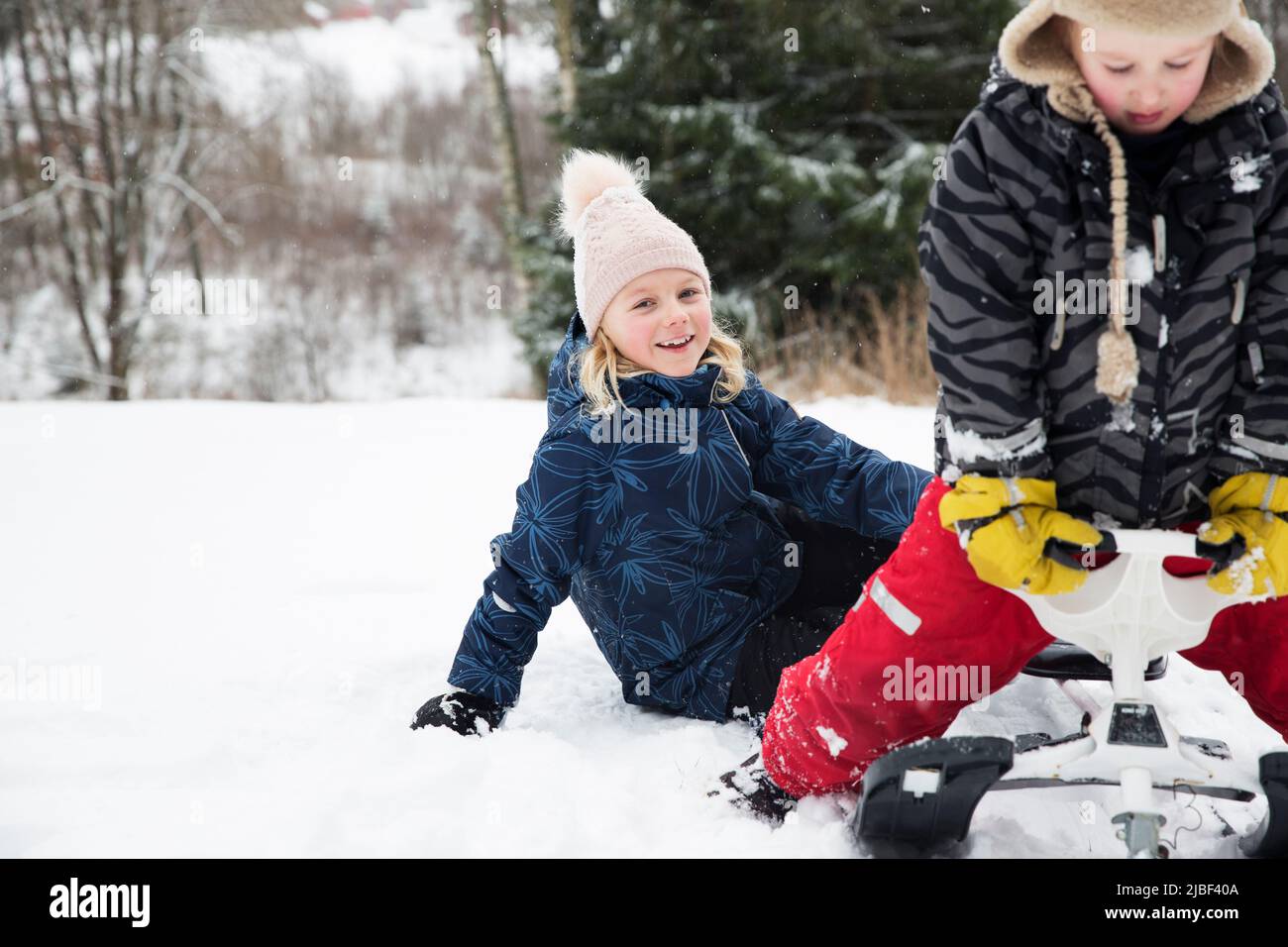 Two girls sledding hi-res stock photography and images - Alamy