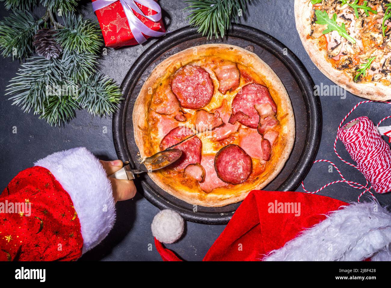 Christmas decorated background with pepperoni and mushrooms pizza,with ...