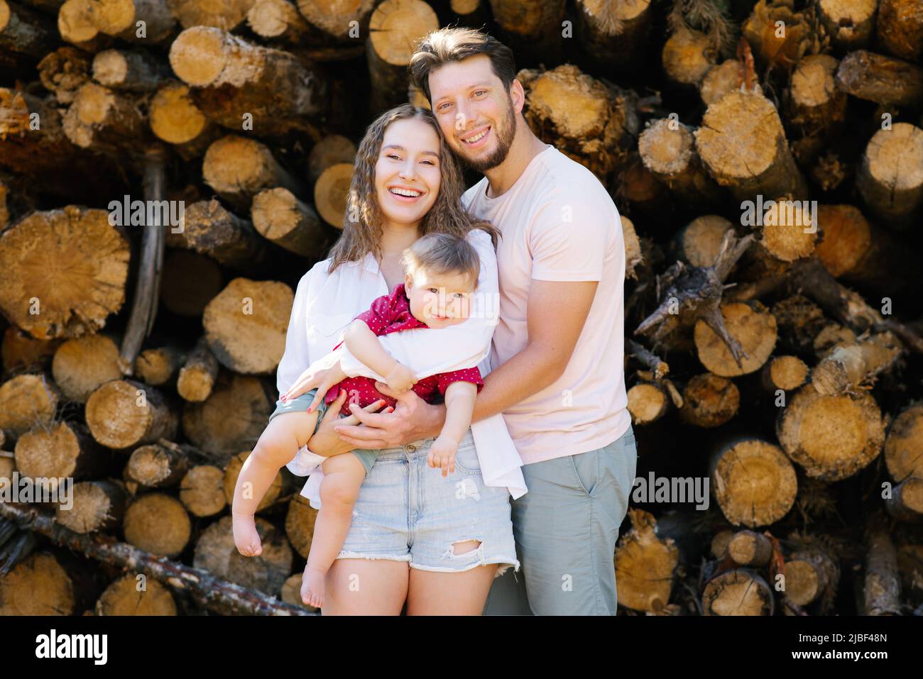 Dad, mom and baby son have fun in the fresh air. A happy family spends ...
