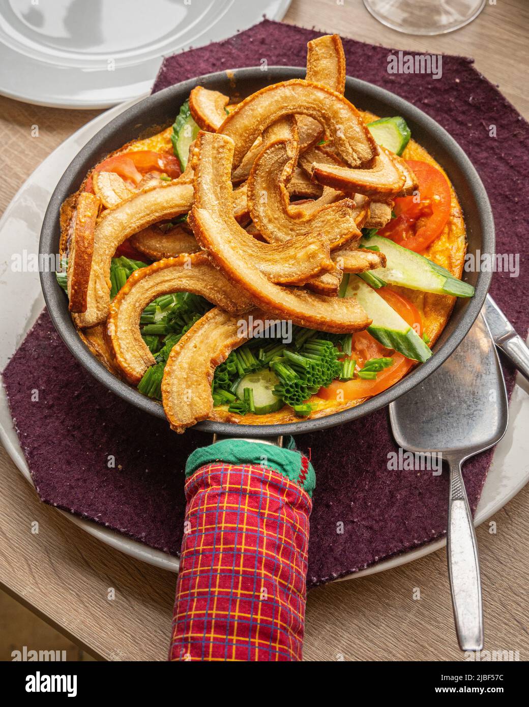 æggekage. Typical Danish dish with egg omelette, roasted pork rind ...