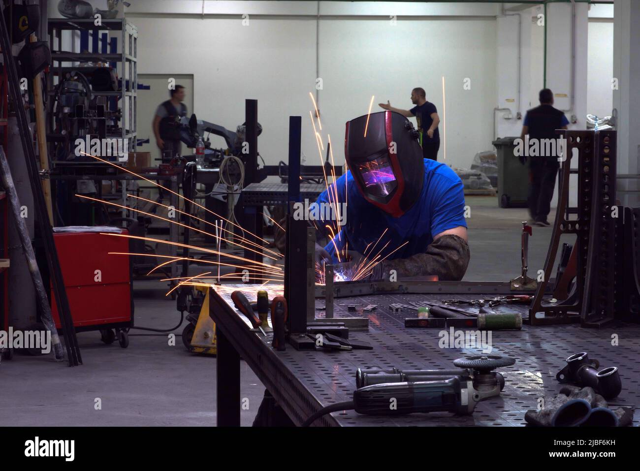 Professional Heavy Industry Welder Working Inside factory, Wears Helmet ...