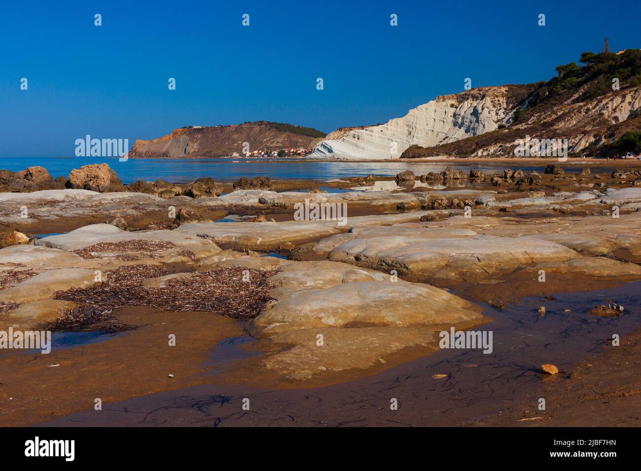 View of the limestone white cliffs with beach at the Scala dei Turchi ...
