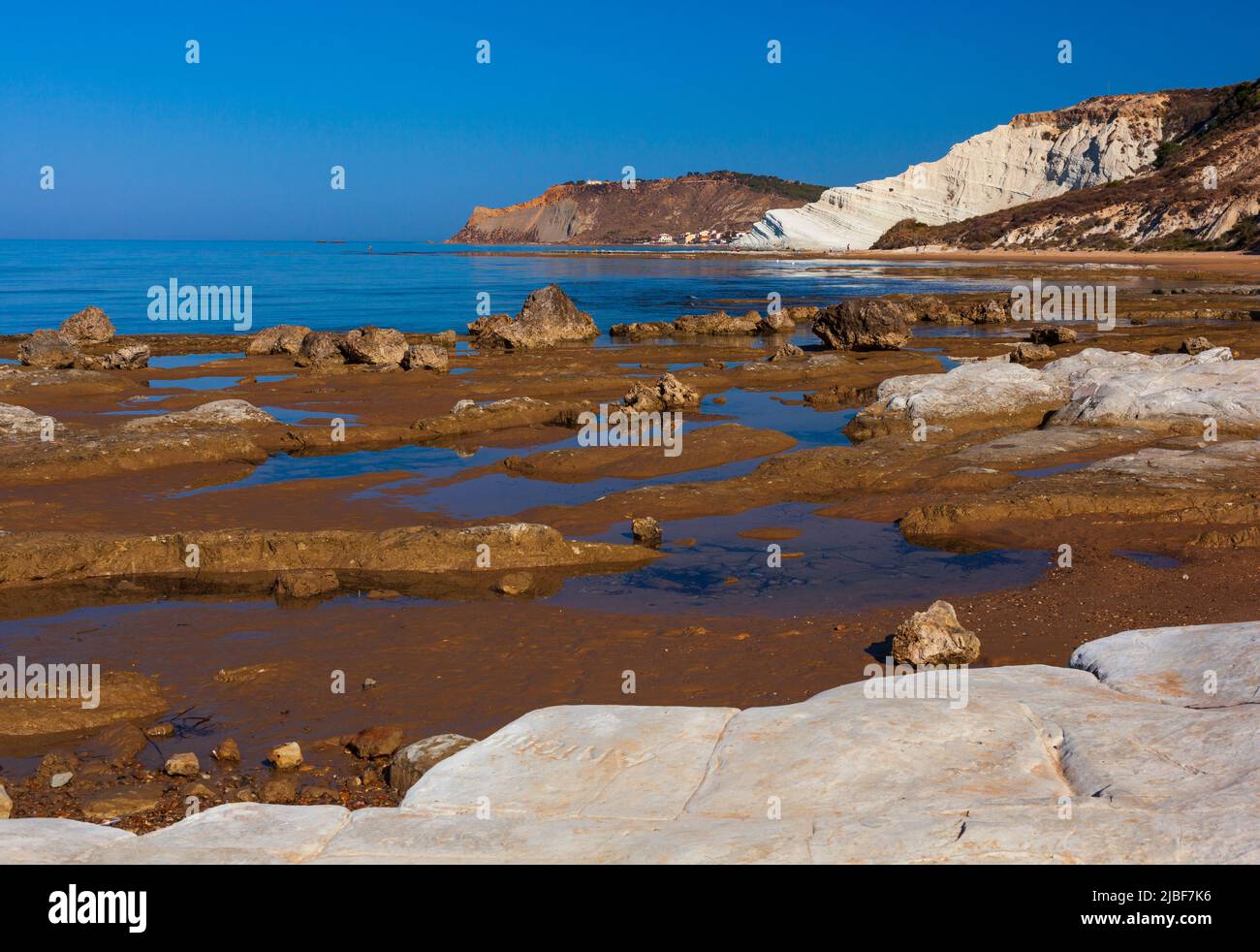 View of the limestone white cliffs with beach at the Scala dei Turchi ...