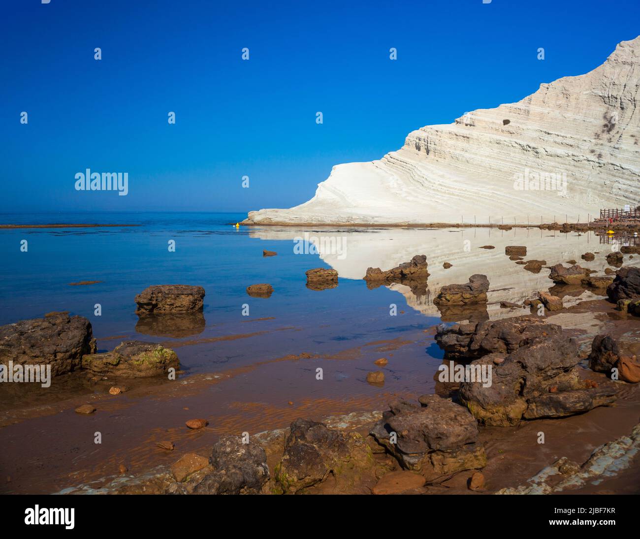 View of the limestone white cliffs with beach at the Scala dei Turchi ...
