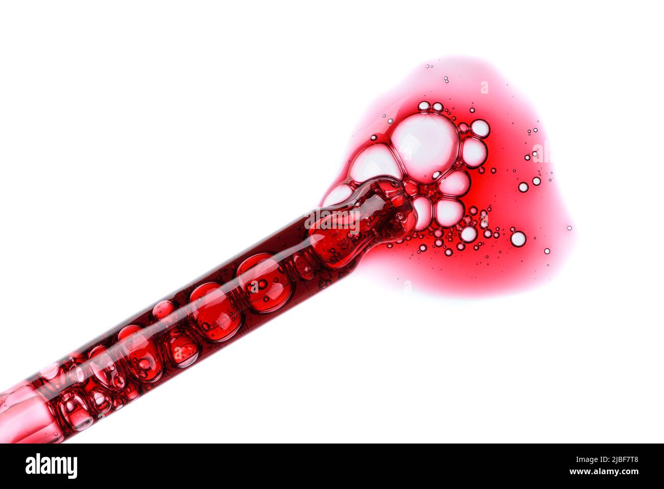 Red serum in cosmetic liquid dropper with large bubbles isolated on ...