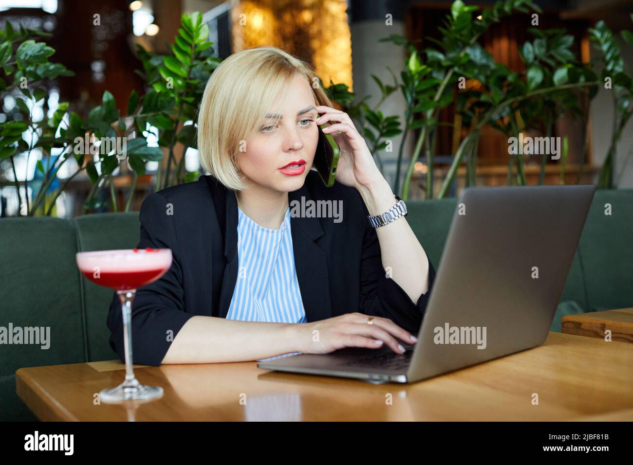 Picture of inspired attractive model writing at her laptop, spending ...