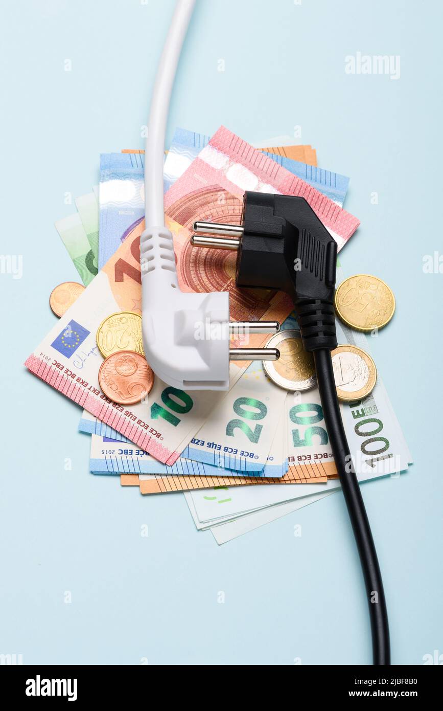 Electric power plugs on Euro banknotes on blue background. Concept of ...