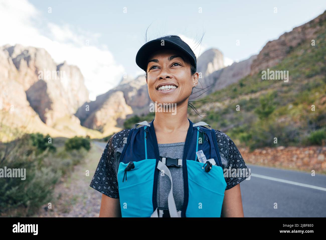 Portrait of a beautiful female hiker in cap. Woman in hiking attire ...