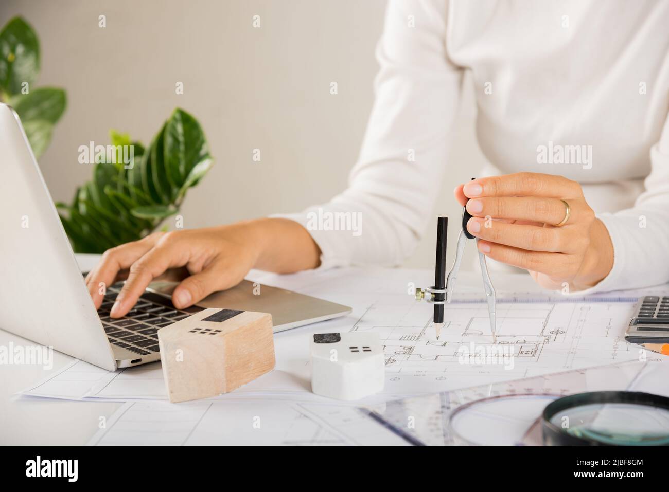 Architectural project workplace. Architect typing laptop keyboard to ...