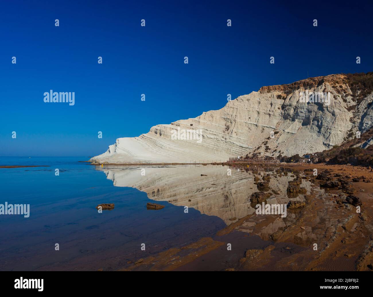View of the limestone white cliffs with beach at the Scala dei Turchi ...