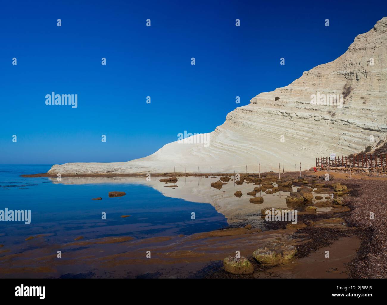 View of the limestone white cliffs with beach at the Scala dei Turchi ...