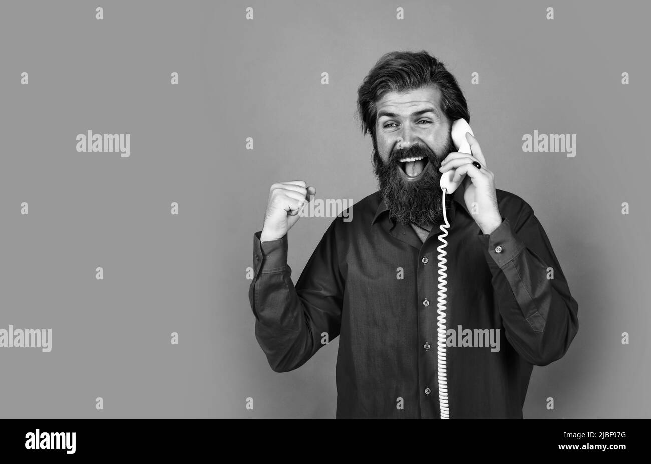 bearded man in shirt call on telephone. casual guy during conversation ...