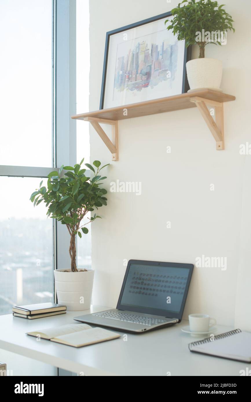 Side view picture of studio workplace with blank notebook, laptop ...