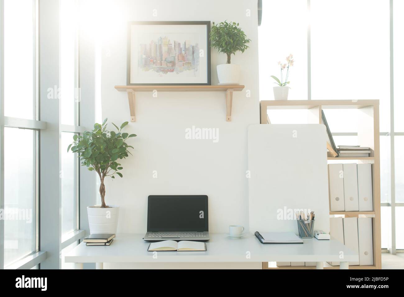 Side view picture of studio workplace with blank notebook, laptop ...