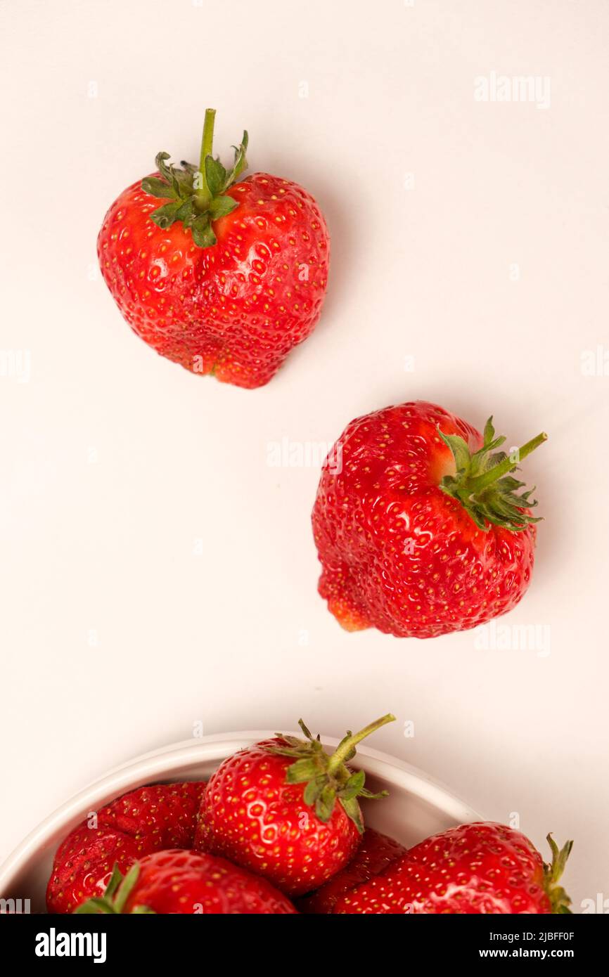 Strawberries on a white background view from above. Two red berries and ...