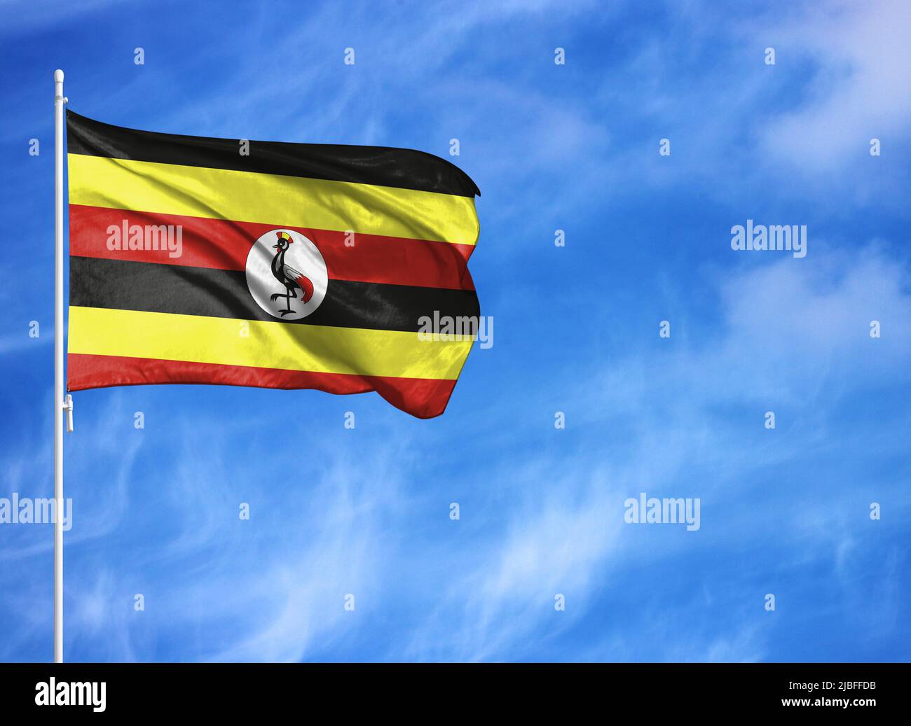 National flag of Uganda on a flagpole Stock Photo - Alamy