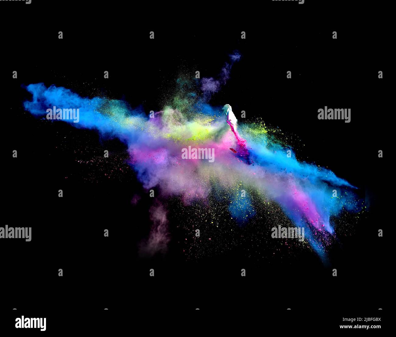 Various multicolored forms of powder paint explode in front of a black ...