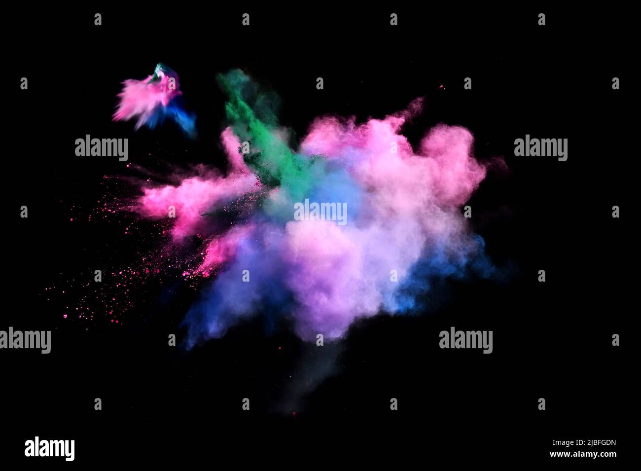 Various multicolored forms of powder paint explode in front of a black ...