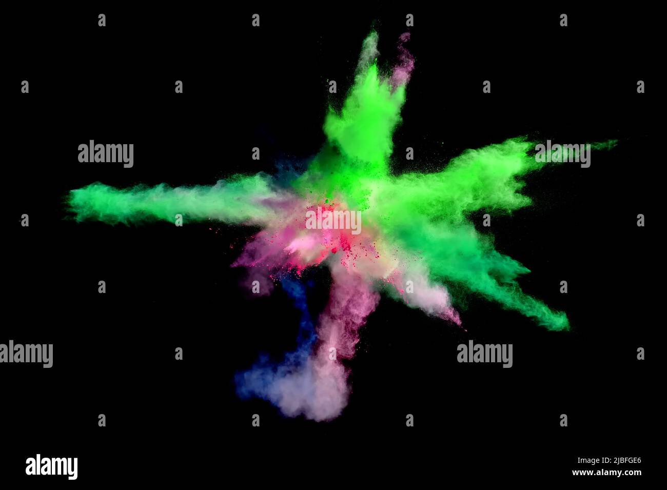 Various multicolored forms of powder paint explode in front of a black ...