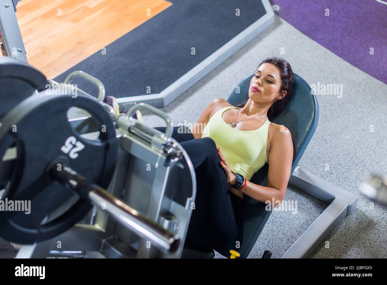 Top view of a fit young woman doing leg press in the gym Stock Photo ...